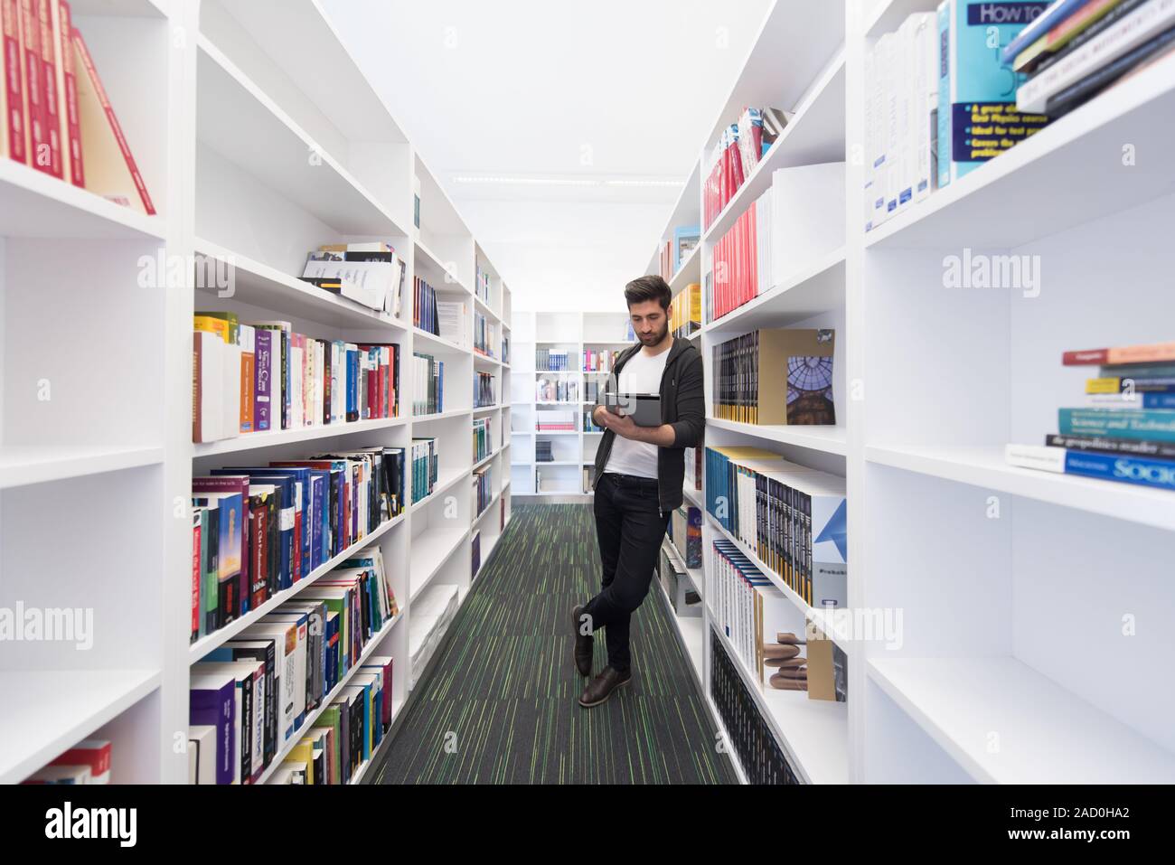 student with tablet in library Stock Photo - Alamy