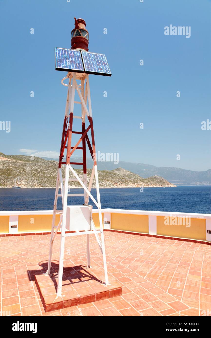 Solar-powered harbour light. Solar-powered light in a harbour ...