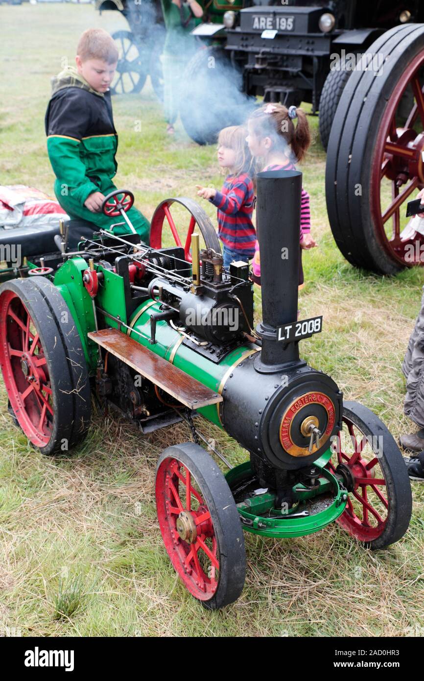 Steam rally. Children looking at a miniature steam engine at a steam ...