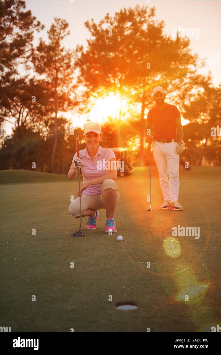 couple on golf course at sunset Stock Photo - Alamy
