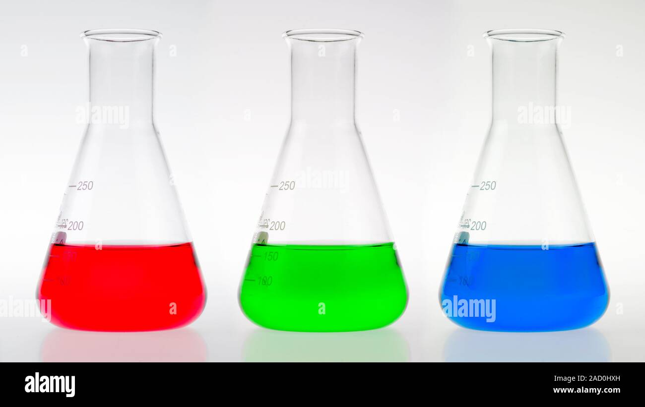 Lab equipment. Conical measuring flasks with various coloured liquids ...