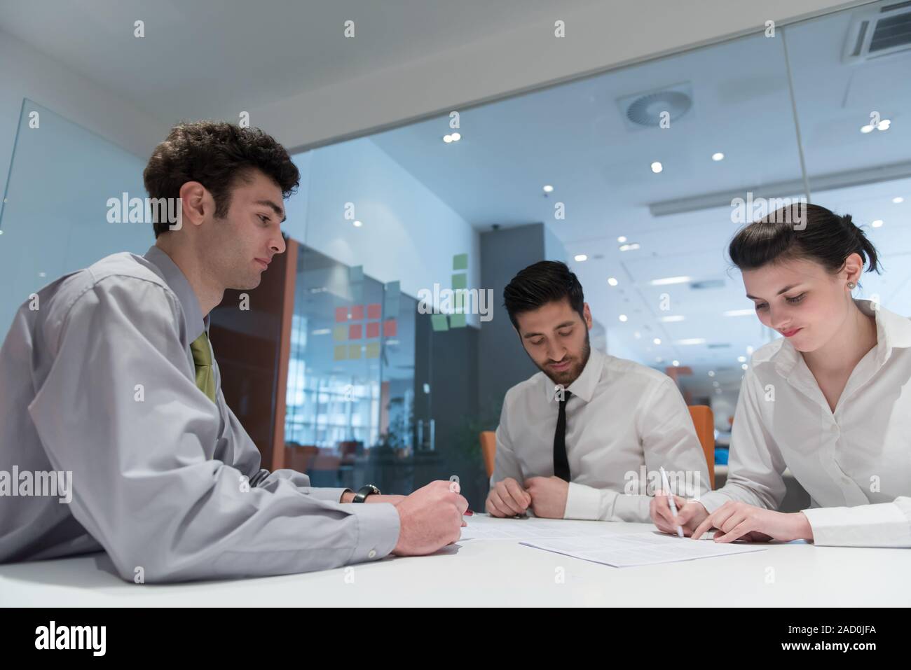 Signing contract on partners back hi-res stock photography and images ...