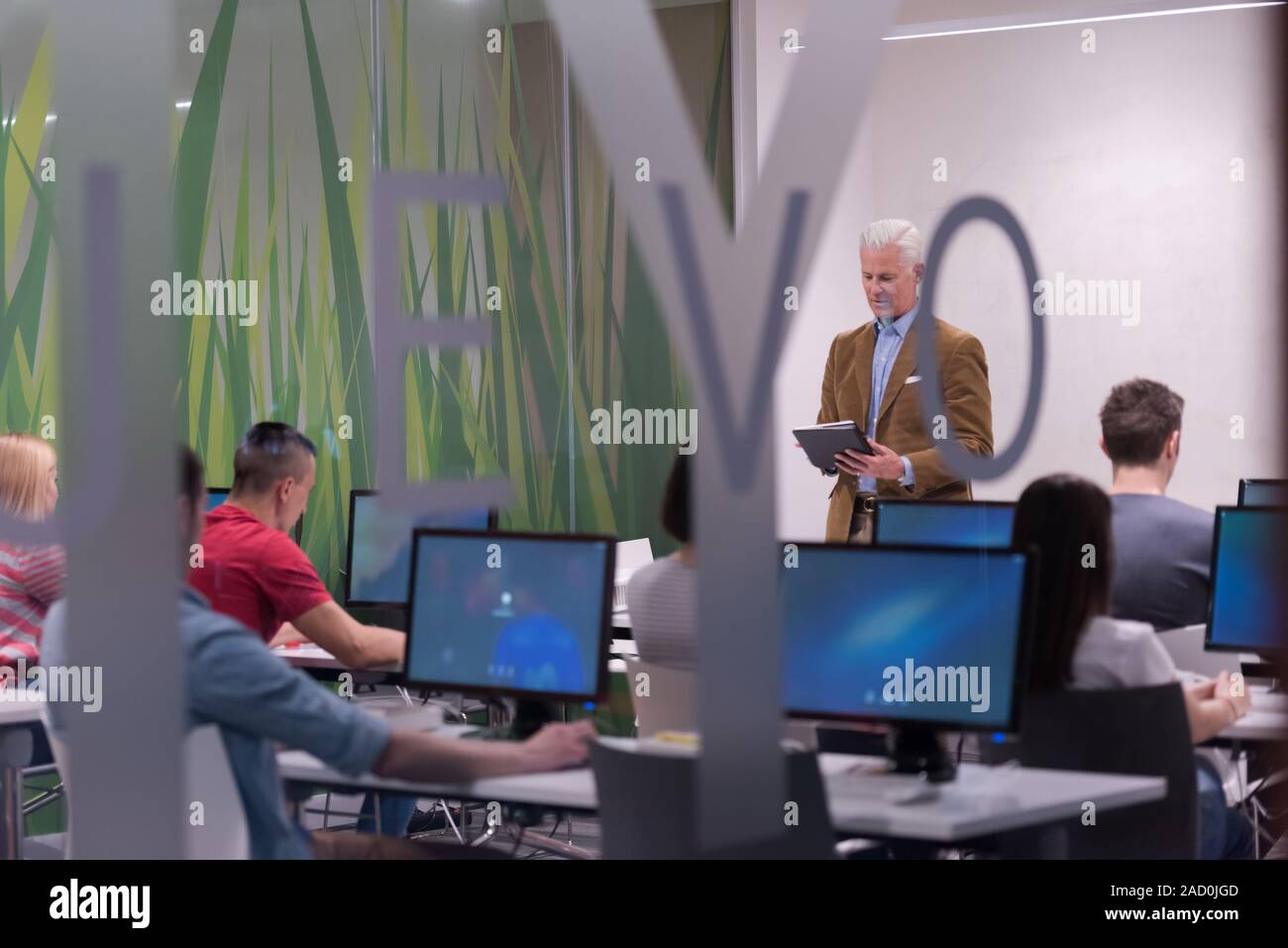 teacher and students in computer lab classroom Stock Photo - Alamy