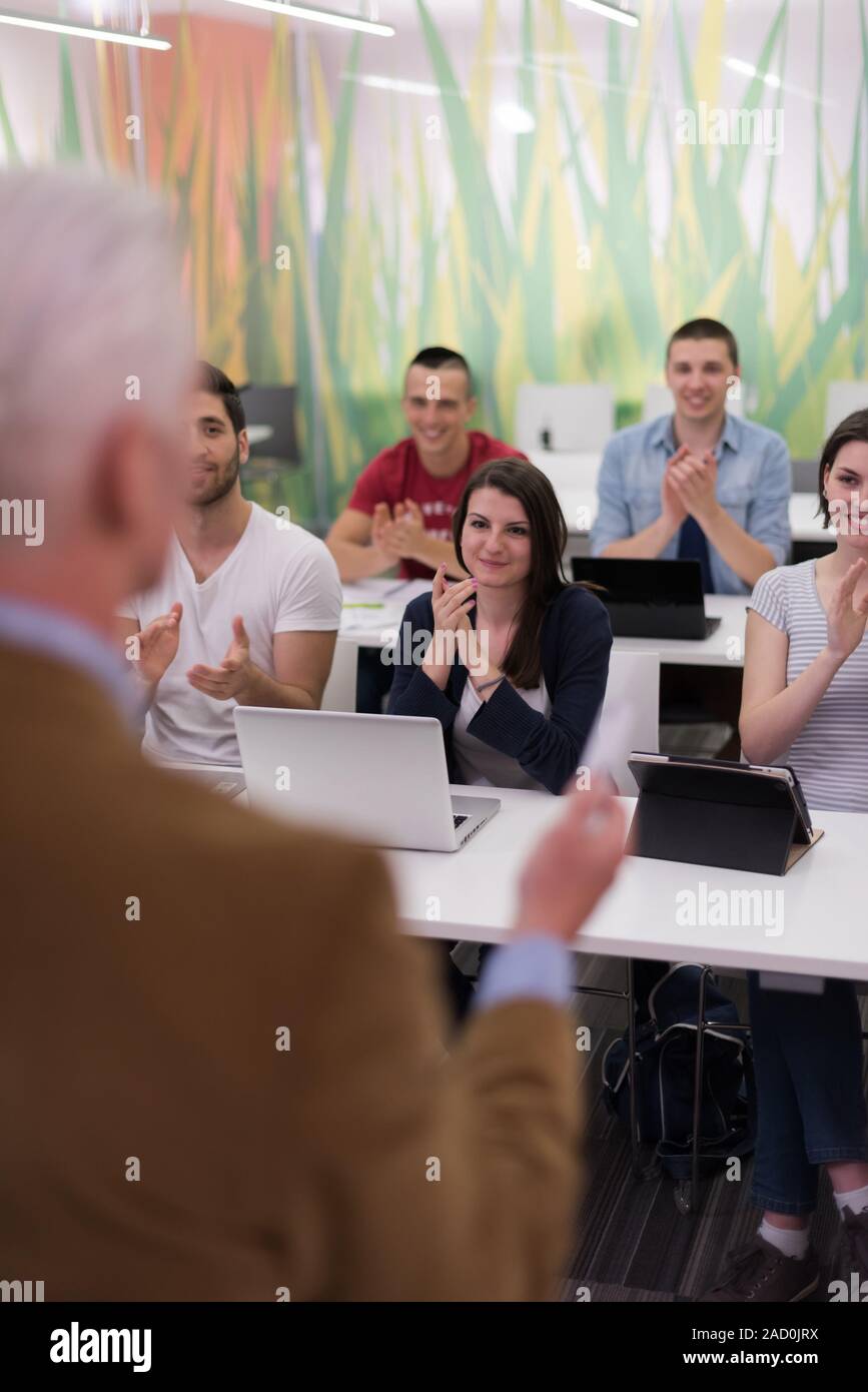 teacher with a group of students in classroom Stock Photo - Alamy