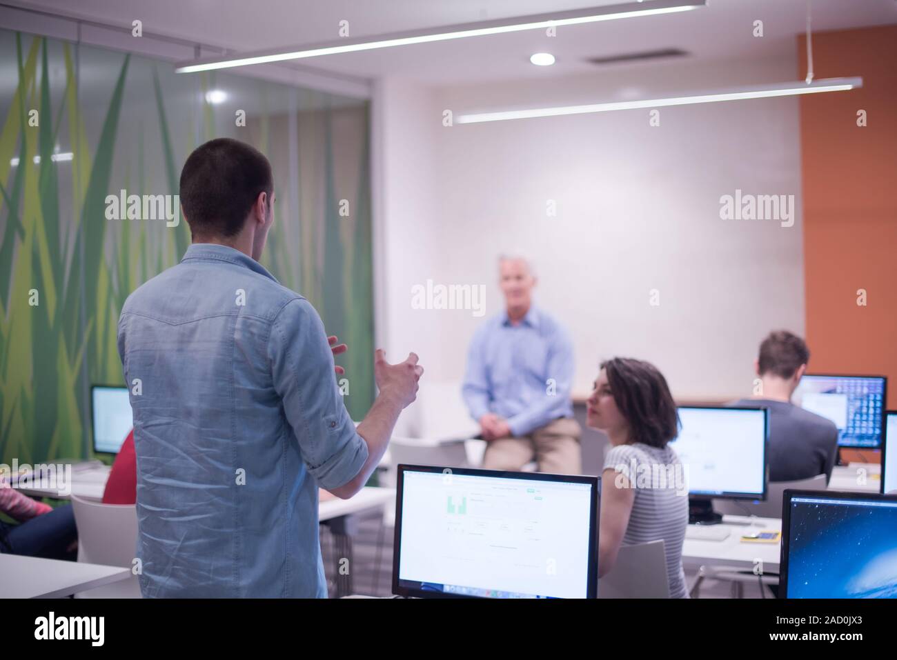 student answering a question in classroom Stock Photo - Alamy
