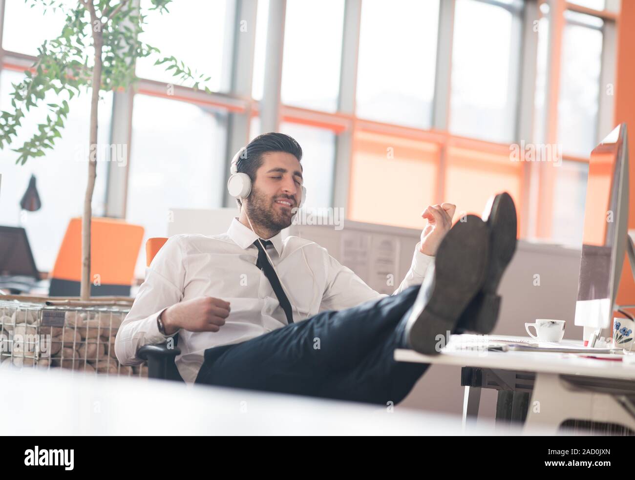relaxed young Business man at office Stock Photo - Alamy