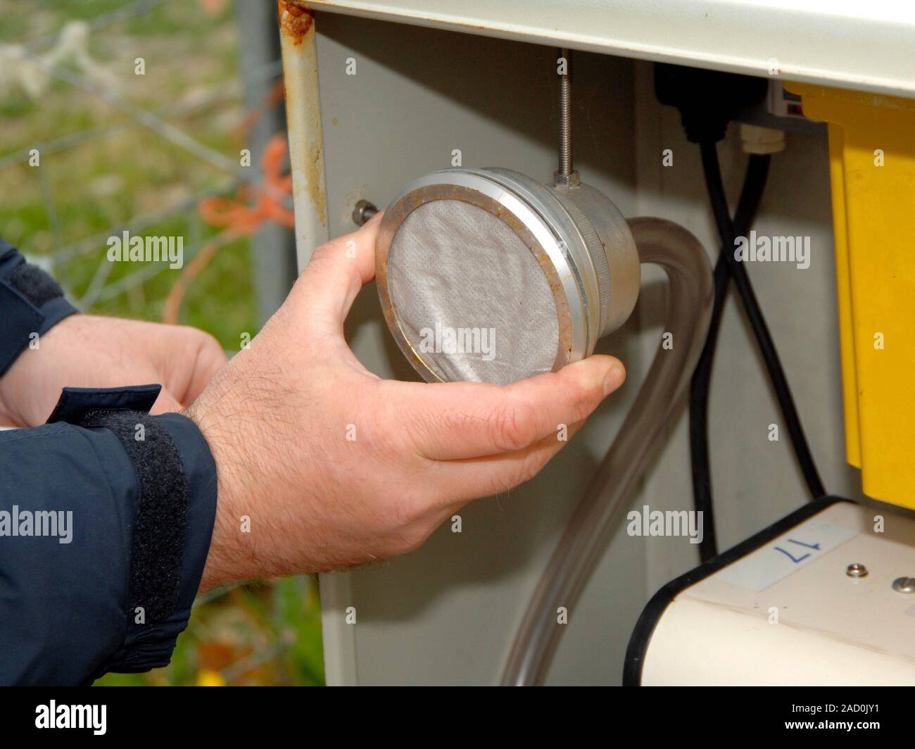 Air quality monitoring. Environmental worker handling the filter in ...
