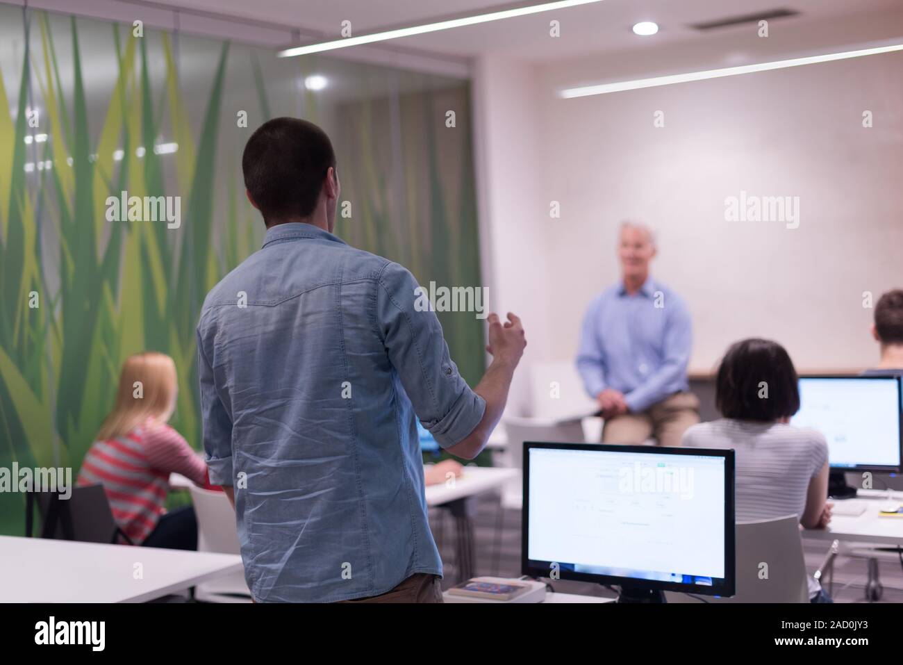 student answering a question in classroom Stock Photo - Alamy