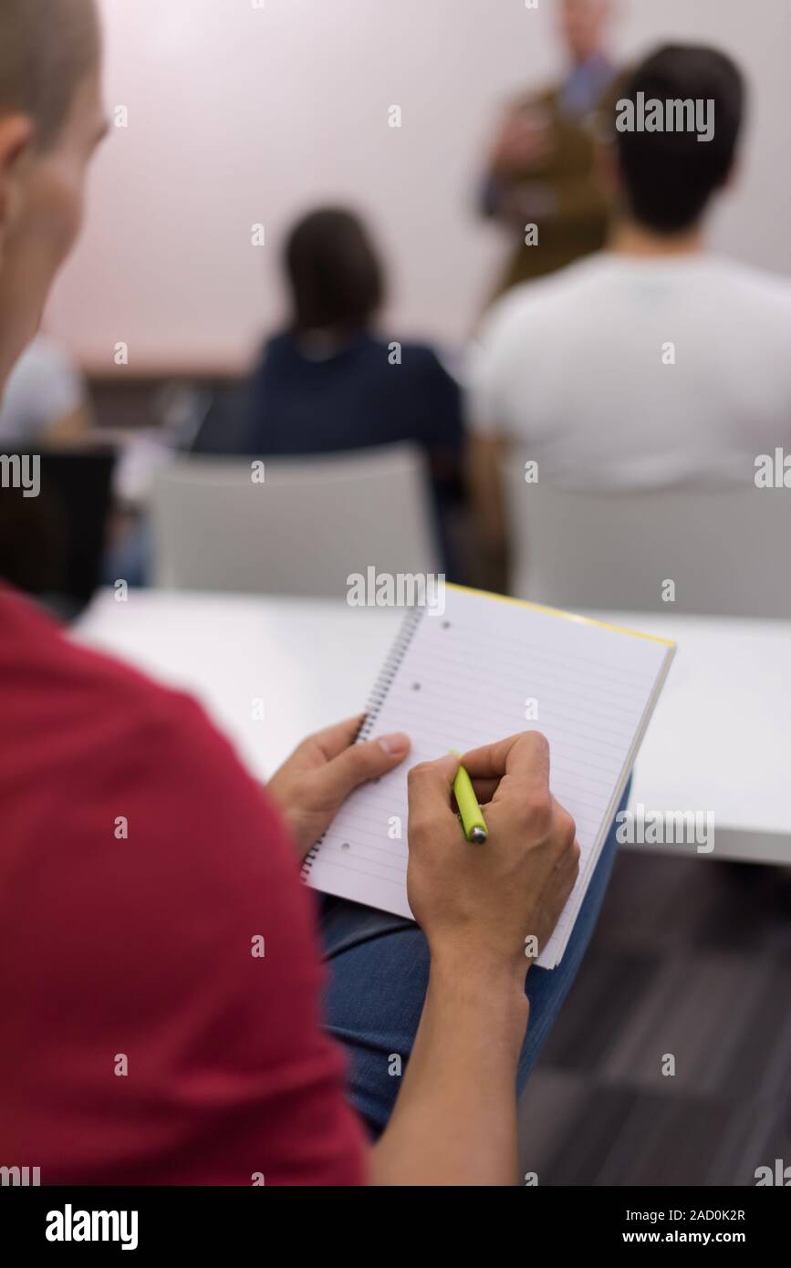 male student taking notes in classroom Stock Photo - Alamy