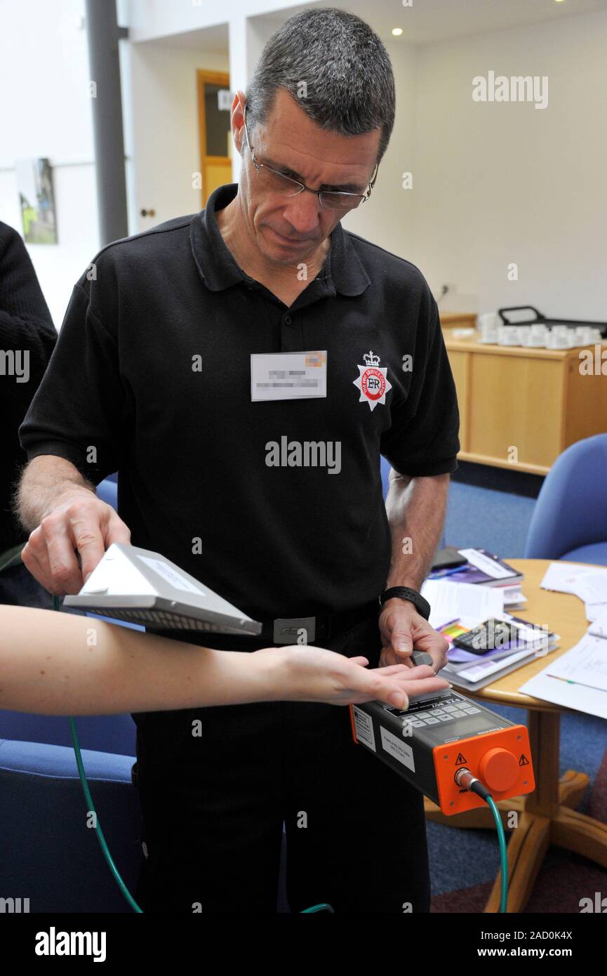 Radiation emergency response training. Fire service trainer showing how ...