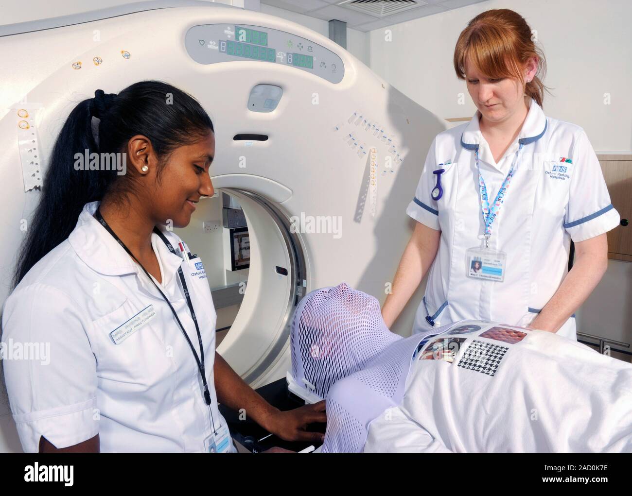 CT scanning for radiotherapy. Medical workers and a patient in the ...