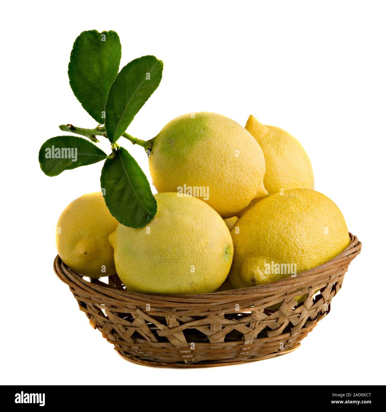 Lemons in basket isolated on white background Stock Photo - Alamy