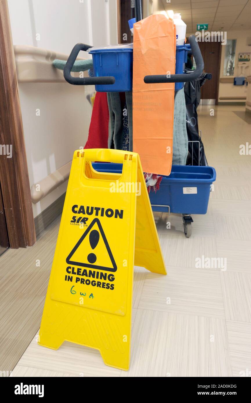 Hospital cleaning equipment, with a sign warning that cleaning is in ...