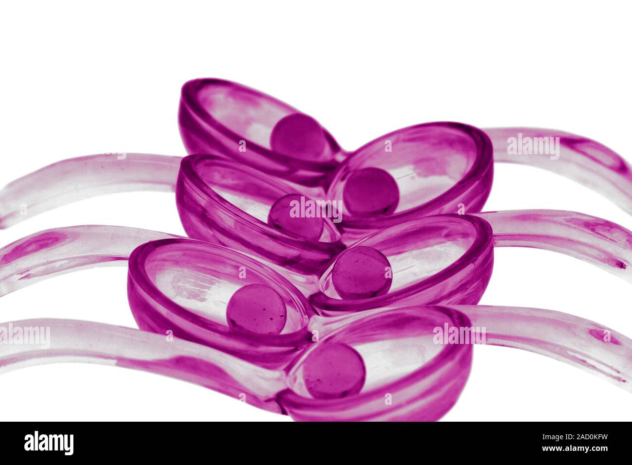Uranium glass spoons, coloured X-ray. Uranium glass is a glass material ...
