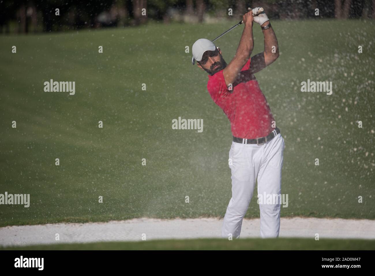 golfer hitting a sand bunker shot Stock Photo - Alamy