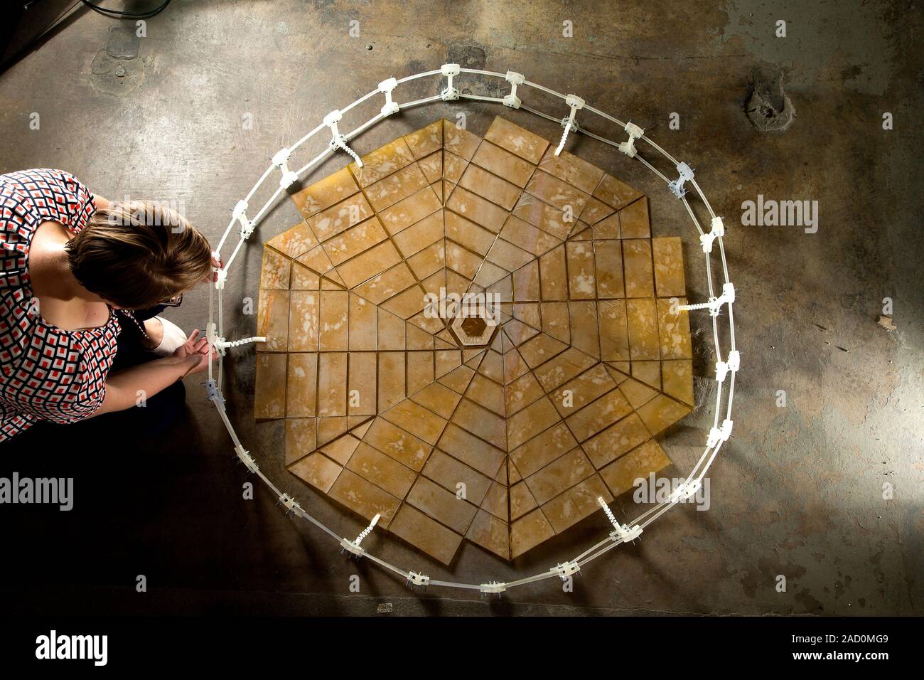 Foldable solar panel array. Mechanical engineering student unfolding a ...