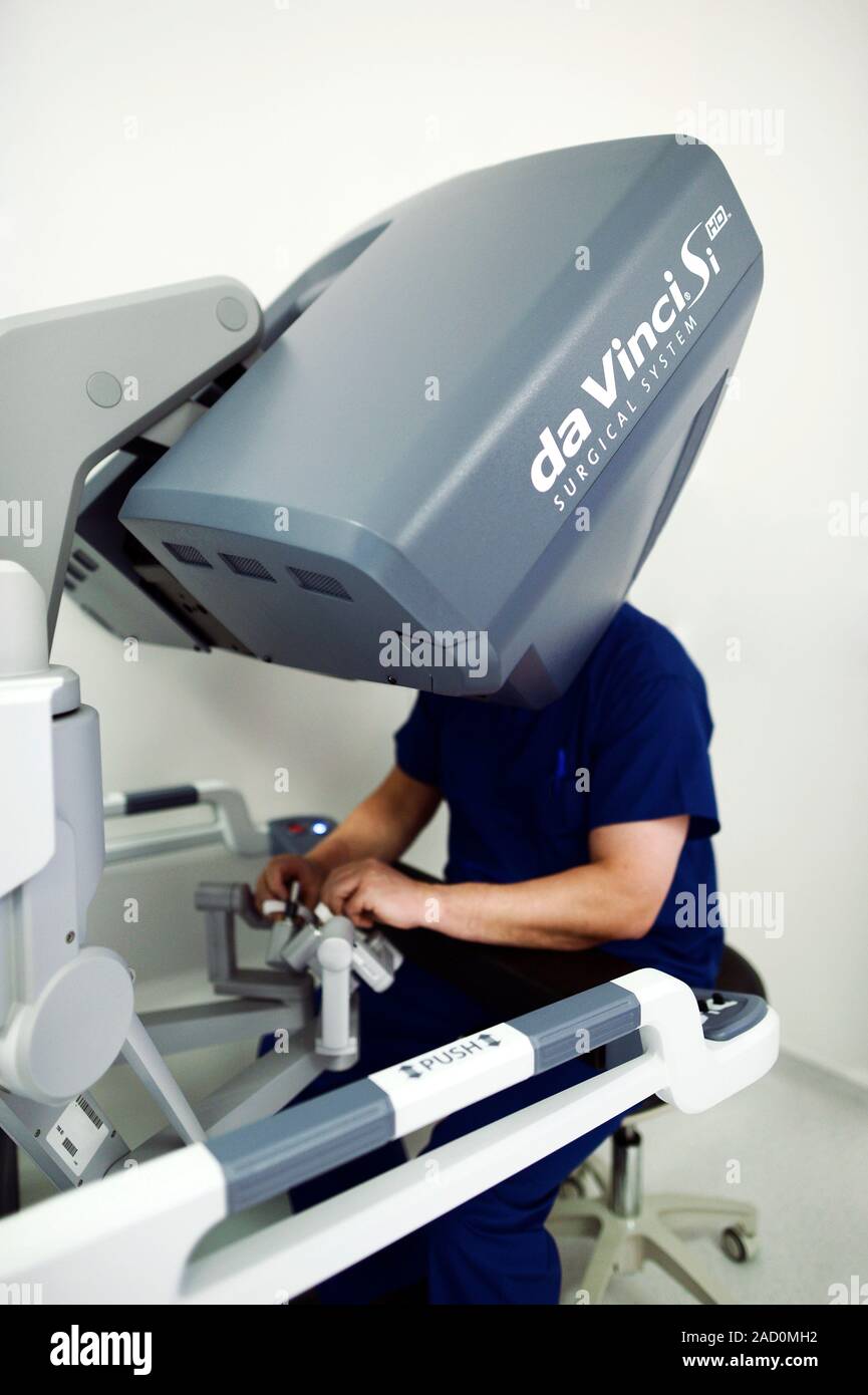 Robot-assisted surgery. Surgeon operating a Da Vinci robotic surgical ...