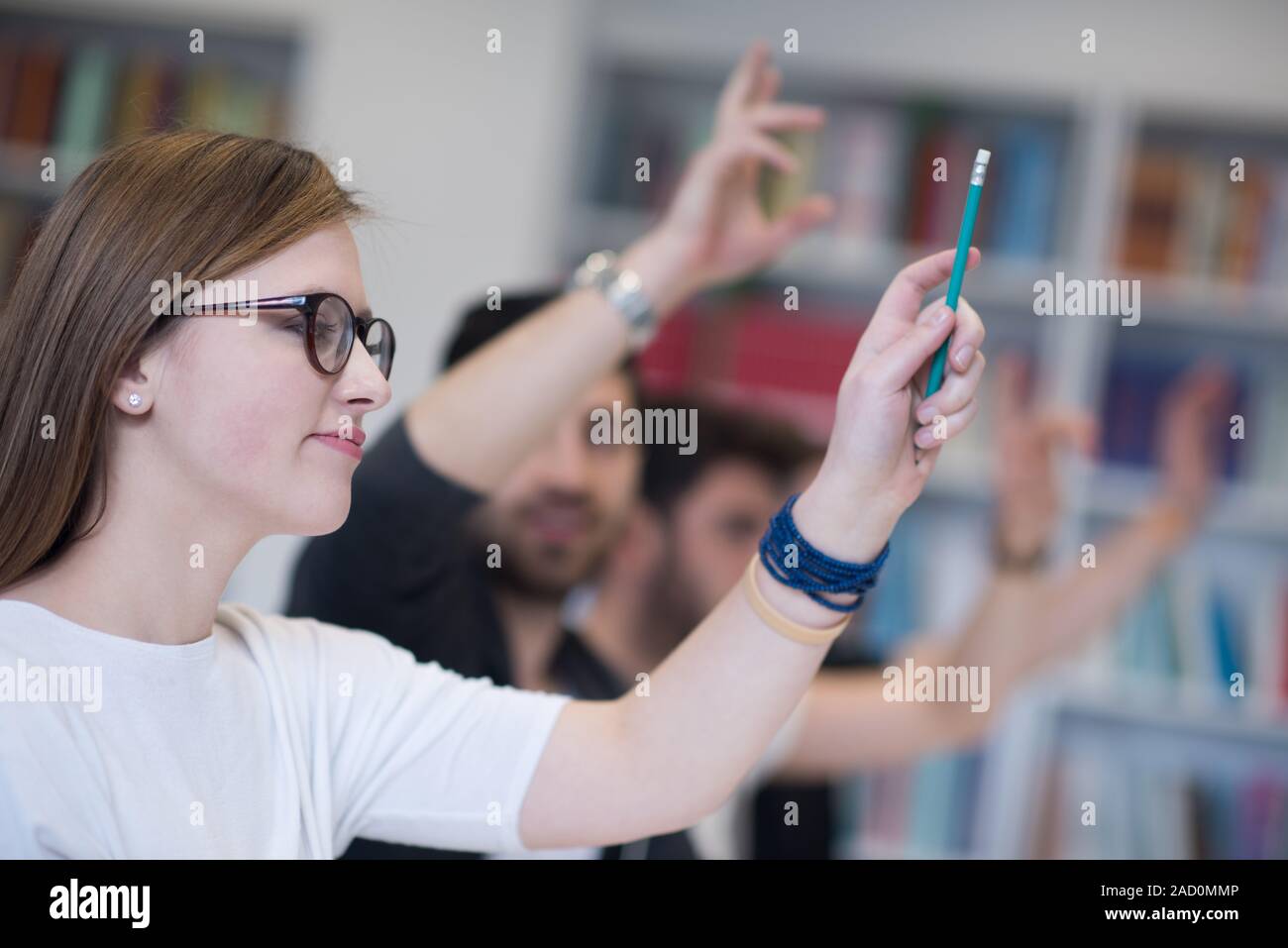 group of students raise hands up Stock Photo - Alamy