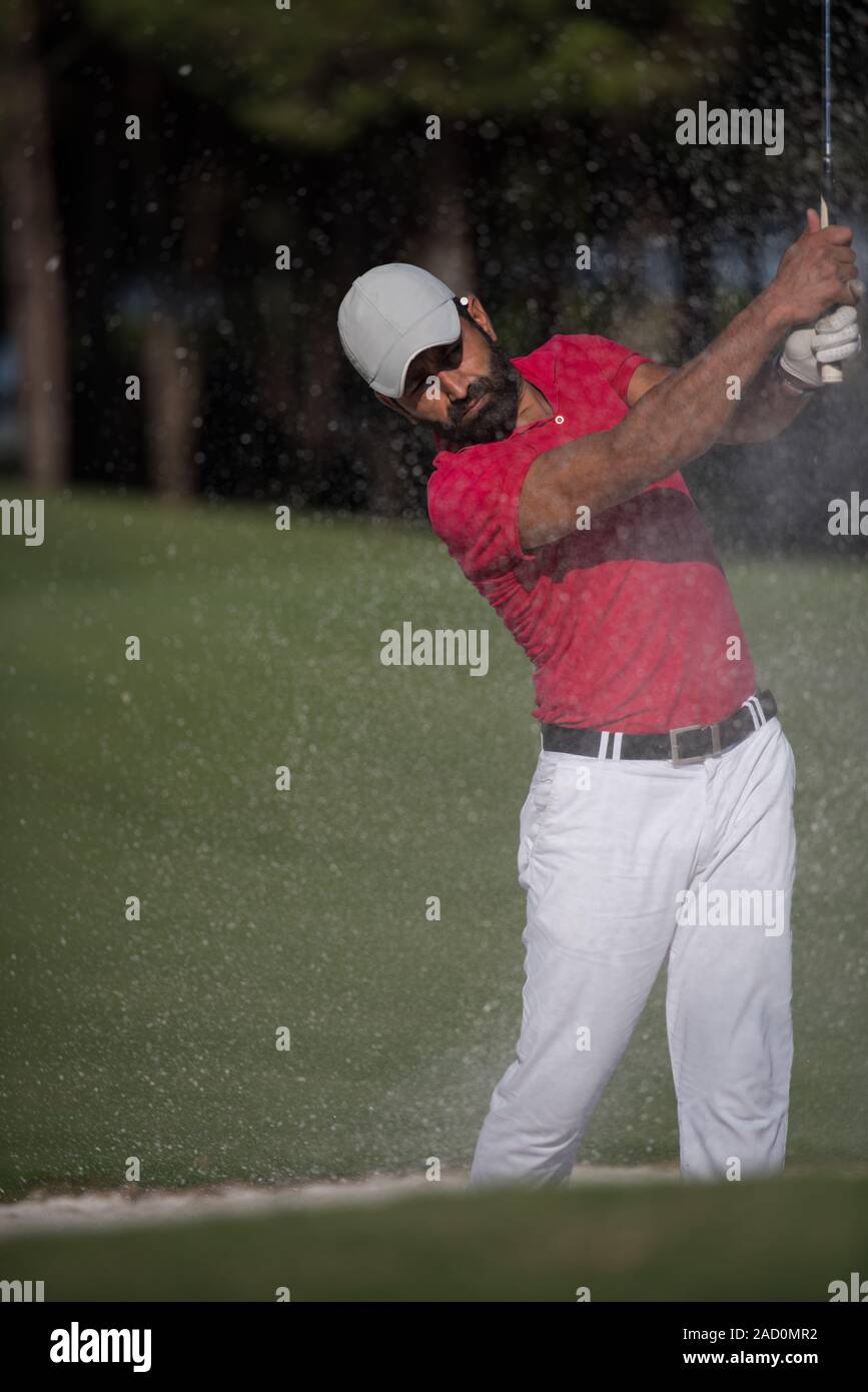 golfer hitting a sand bunker shot Stock Photo - Alamy