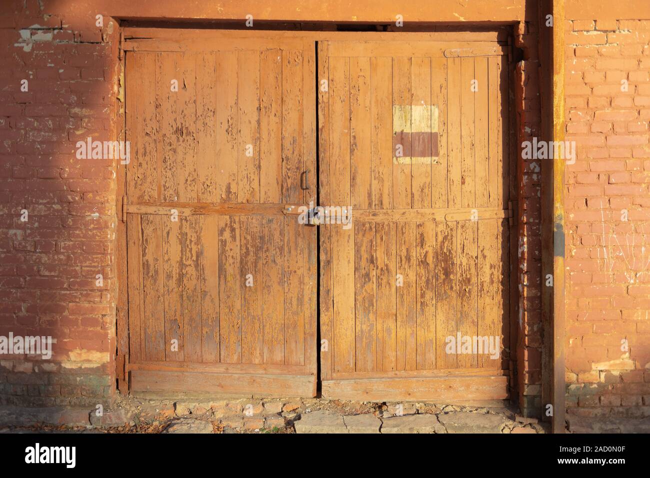 Wooden gate. A gate in an old brick wall with peeling paint Stock Photo ...