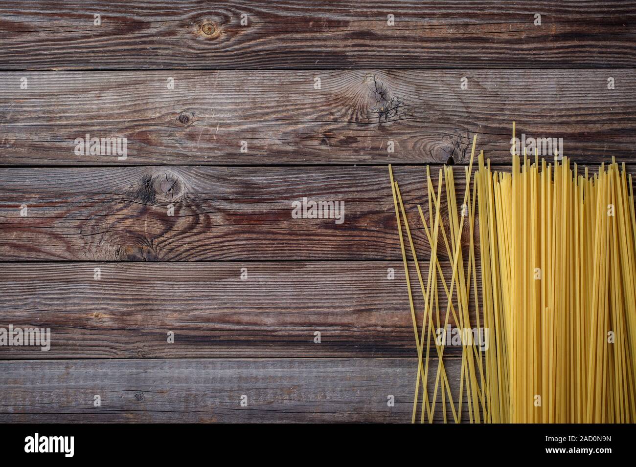 Yellow long spaghetti on black background. Raw spaghetti Stock Photo ...