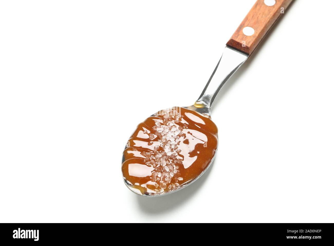 Spoon with salted caramel isolated on white background Stock Photo - Alamy
