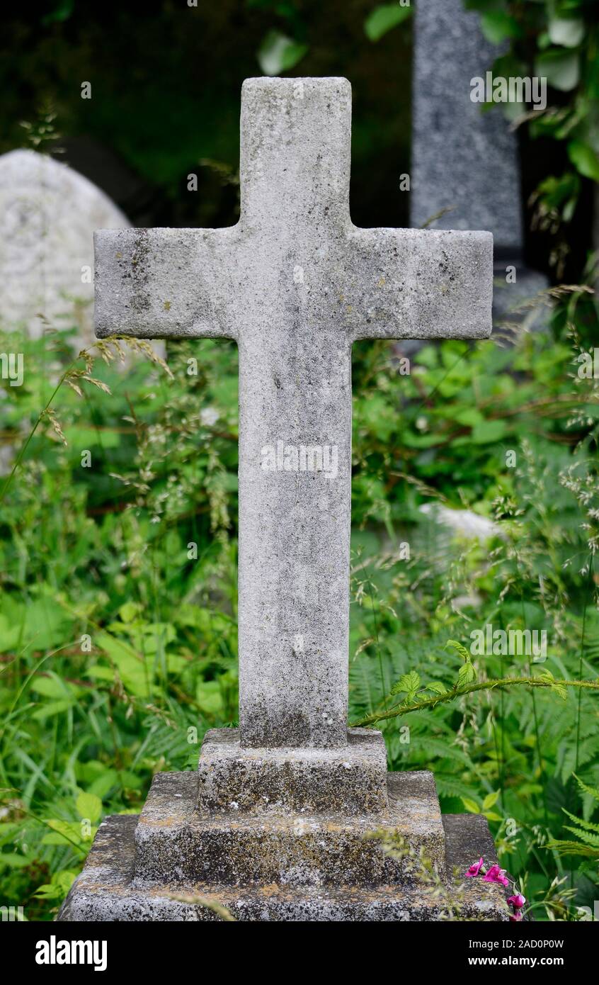 Stone cross in an urban cemetery. Photographed in Brompton Cemetery ...
