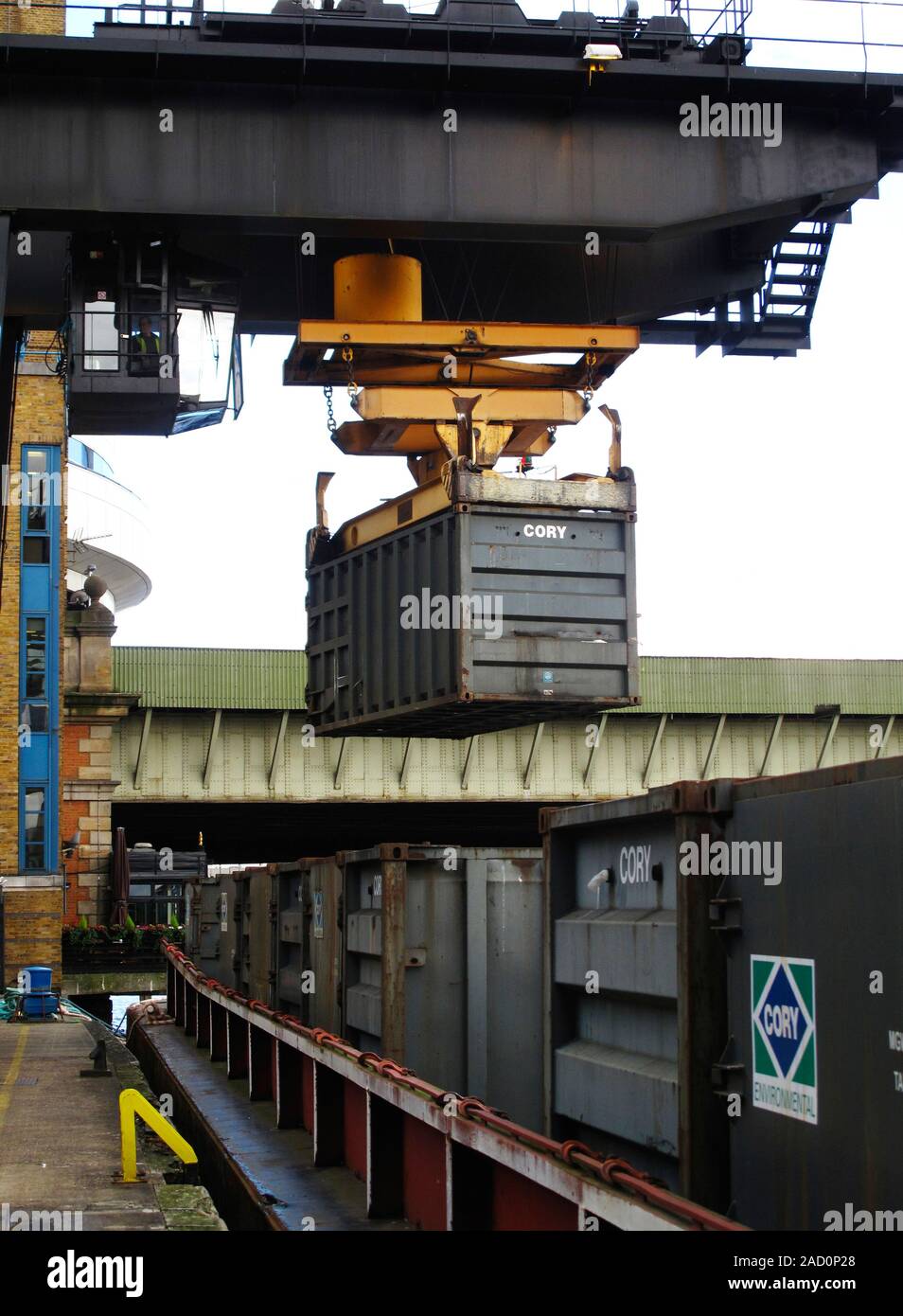 Thames container crane. A crane loading a barge with containers on the ...