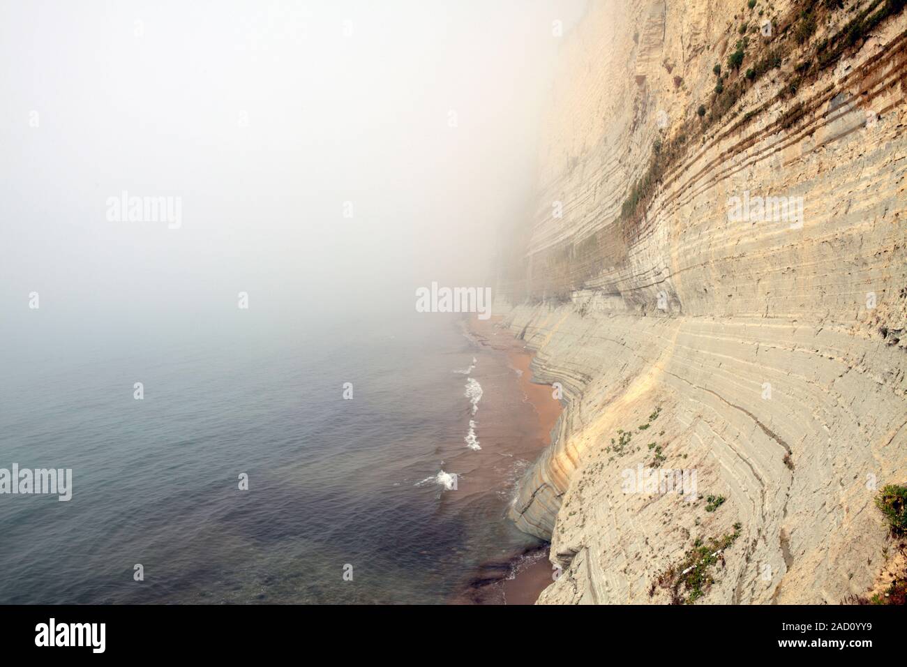 Sea mist and sandstone cliffs. Sea mist surrounding coastal sandstone ...