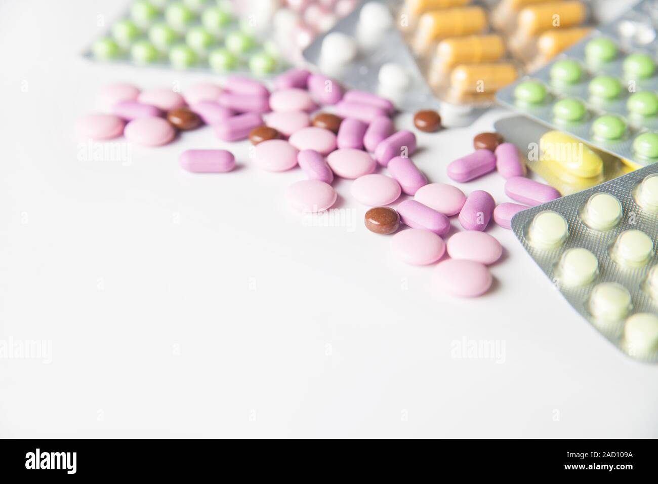 Colorful tablets on white background Stock Photo - Alamy