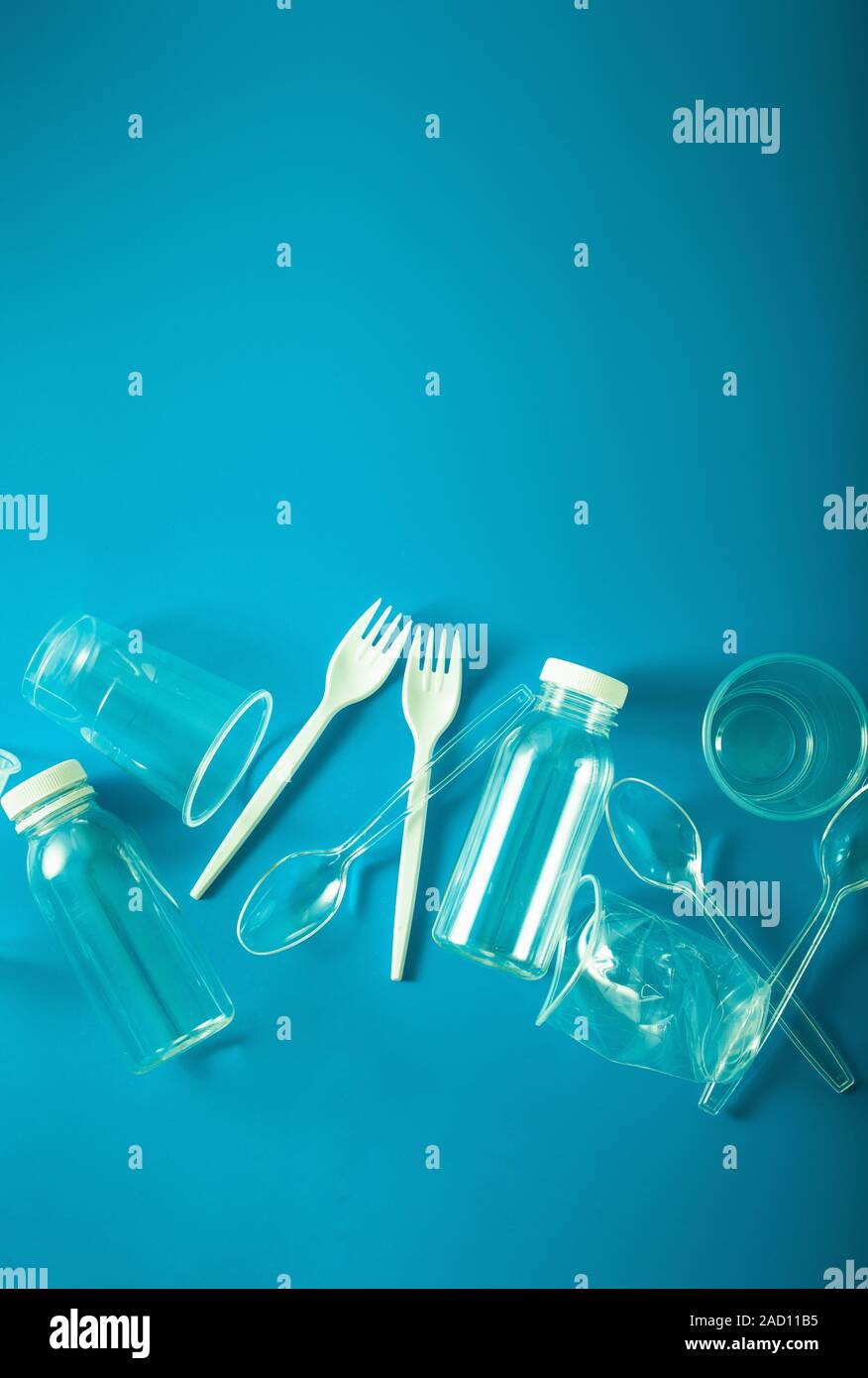 single use plastic bottles, cups, forks, spoons. concept of recycling ...