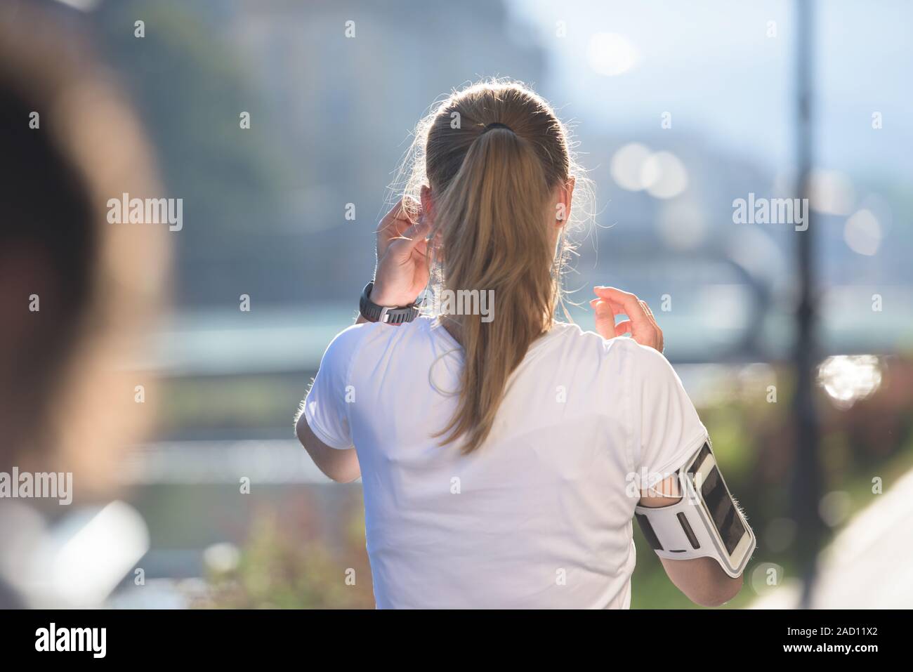 jogging woman setting phone before jogging Stock Photo - Alamy
