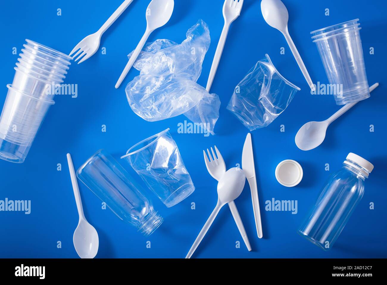 single use plastic bottles, cups, forks, spoons. concept of recycling ...