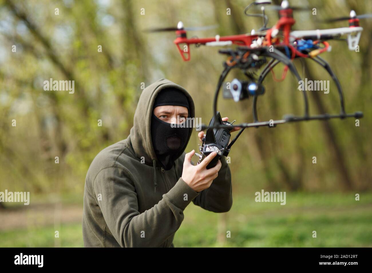 Man in mask operating a drone with remote control Stock Photo - Alamy