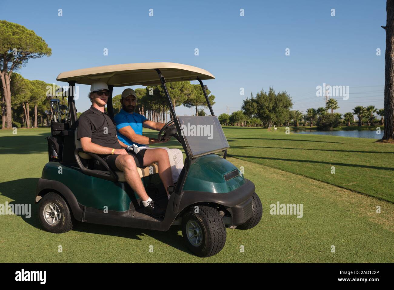 Golf players driving cart hi-res stock photography and images - Alamy