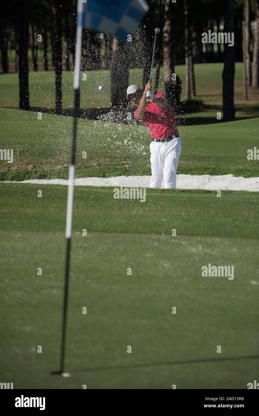 golfer hitting a sand bunker shot Stock Photo - Alamy