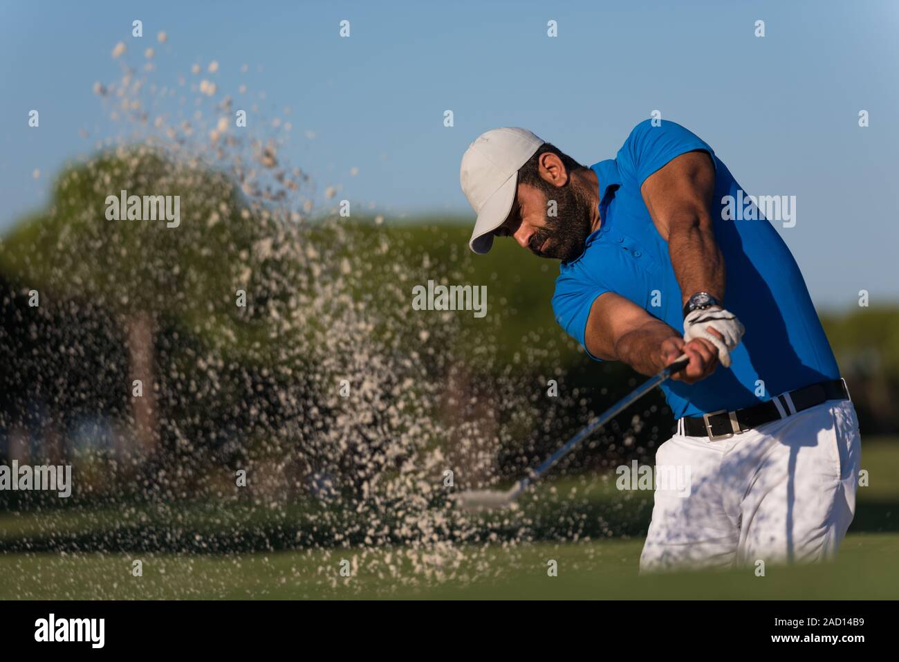 pro golfer hitting a sand bunker shot Stock Photo - Alamy