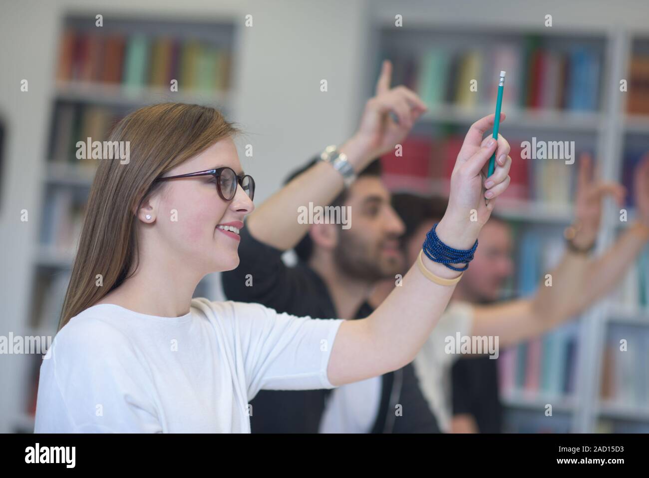 group of students raise hands up Stock Photo - Alamy