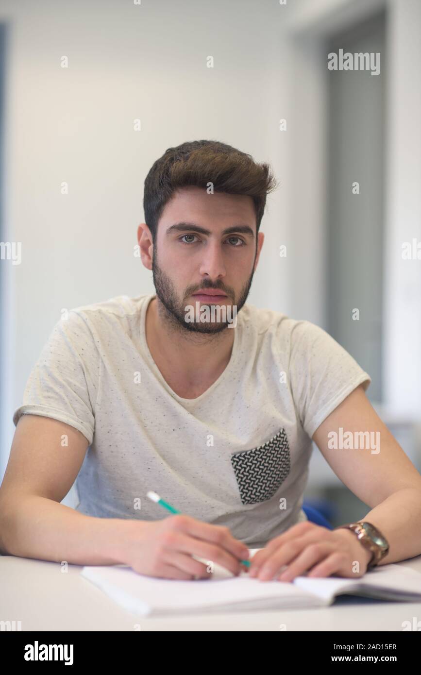 male student taking notes in classroom Stock Photo - Alamy