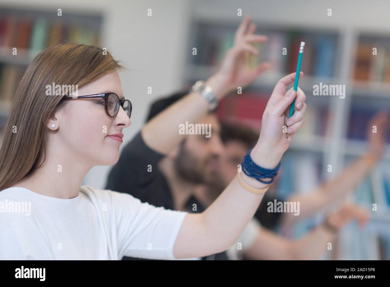 group of students raise hands up Stock Photo - Alamy