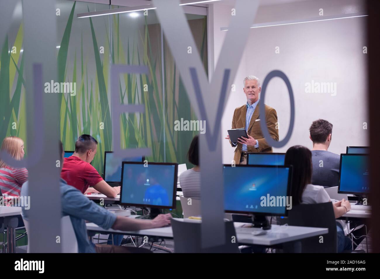 teacher and students in computer lab classroom Stock Photo - Alamy