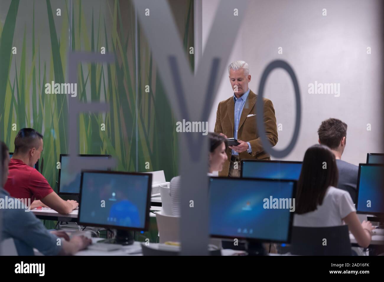 teacher and students in computer lab classroom Stock Photo - Alamy