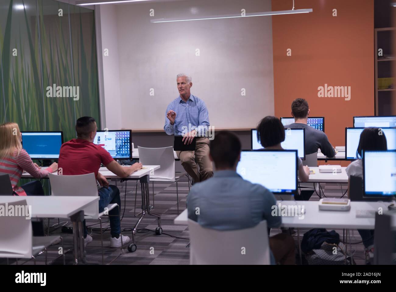 teacher and students in computer lab classroom Stock Photo - Alamy