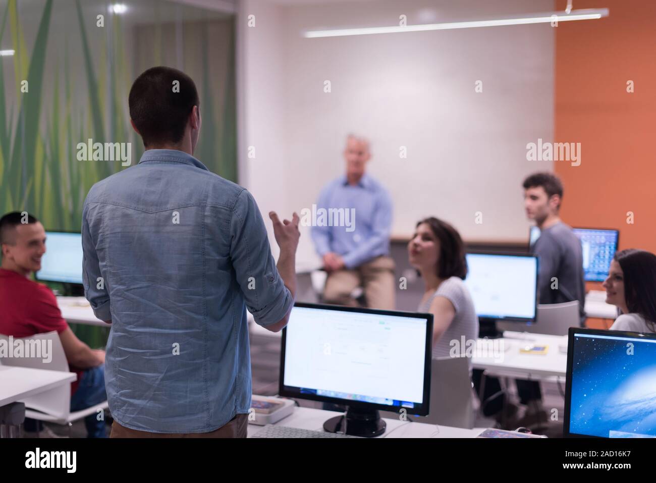 student answering a question in classroom Stock Photo - Alamy