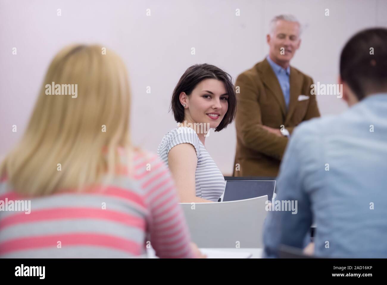 teacher with a group of hi school students in classroom Stock Photo - Alamy