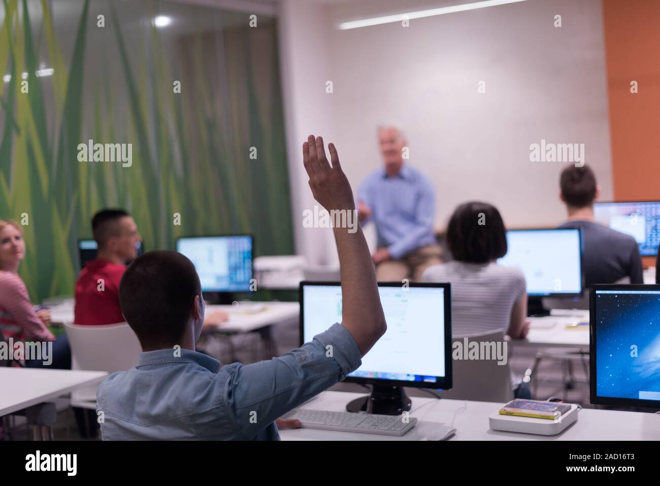 student answering a question in classroom Stock Photo - Alamy