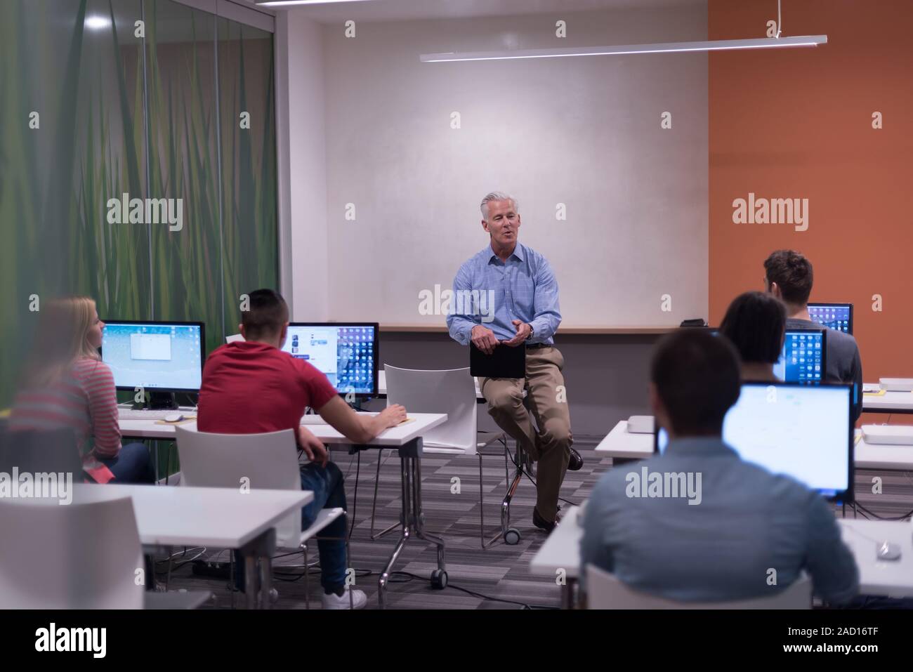 teacher and students in computer lab classroom Stock Photo - Alamy