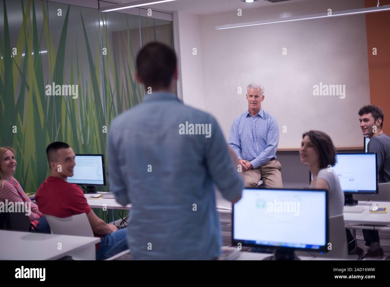 student answering a question in classroom Stock Photo - Alamy