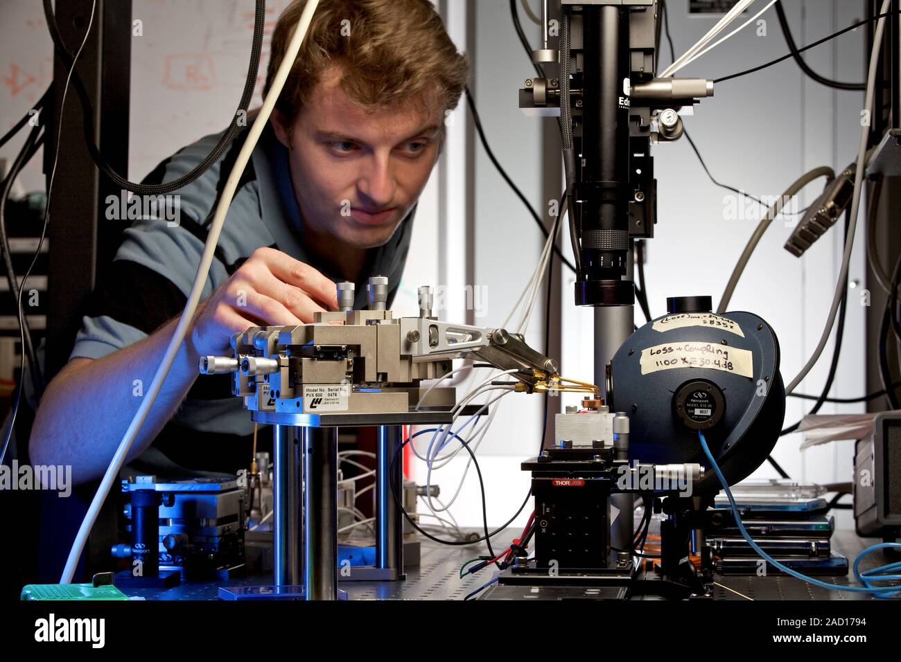 Computing laboratory. Researcher analysing an integrated circuit in a ...