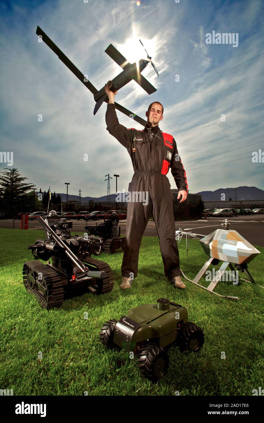 Military robots and operator. Land and air-based robots and drones ...